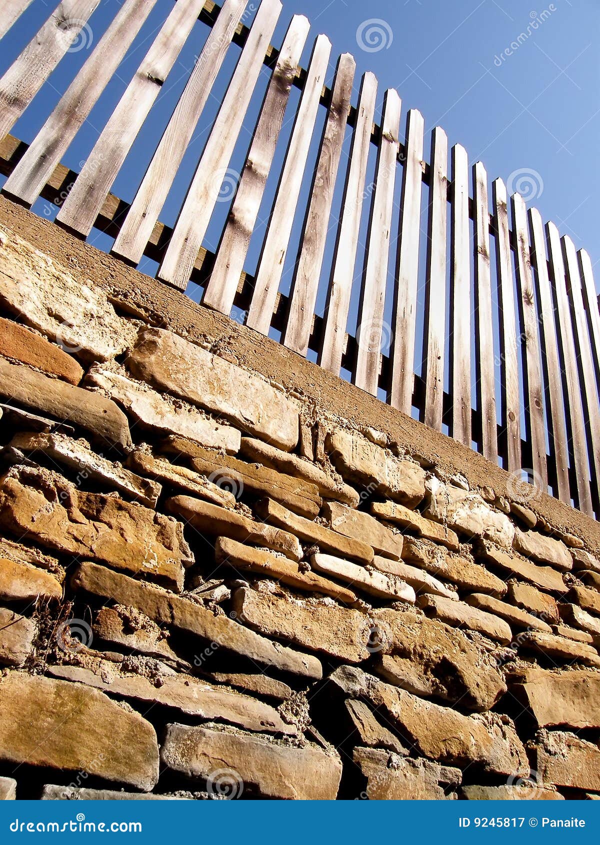Wooden fence on stone wall stock image. Image of wide - 9245817