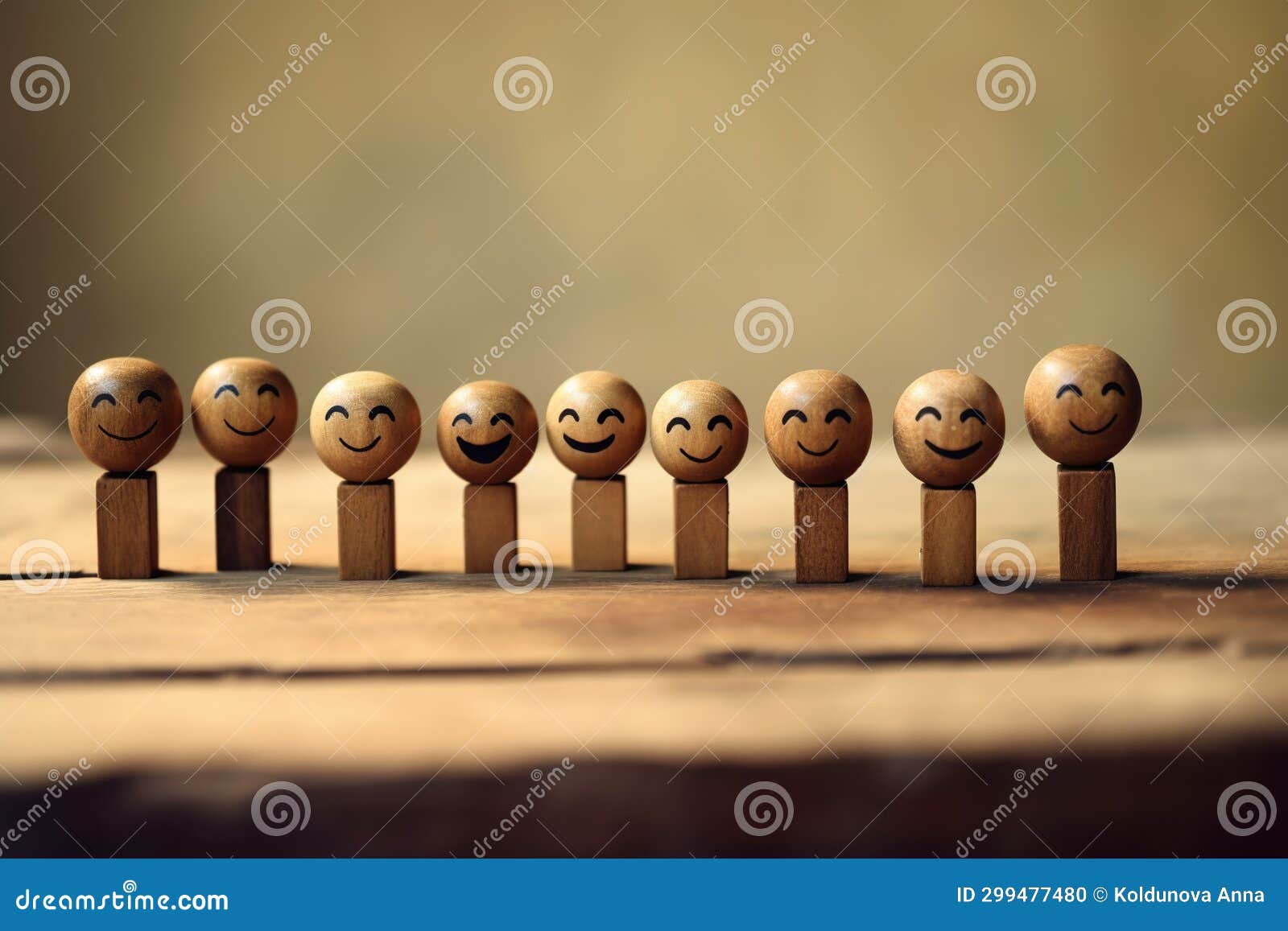 Wooden Figures Lined Up on a Wooden Table with a Smile Stock Photo ...