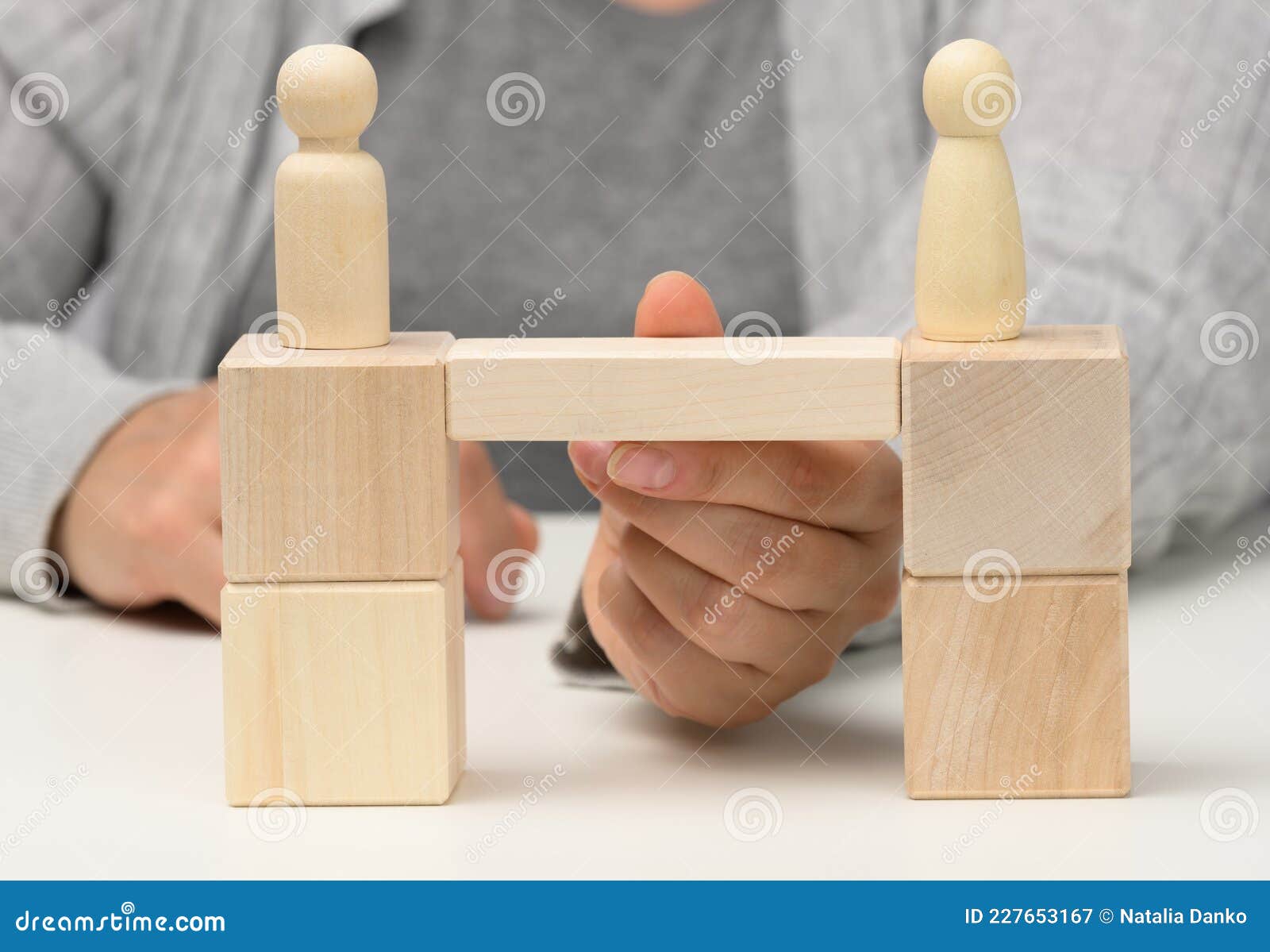 Wooden Figures Stand on the Bridge from the Sides Opposite Each Other ...