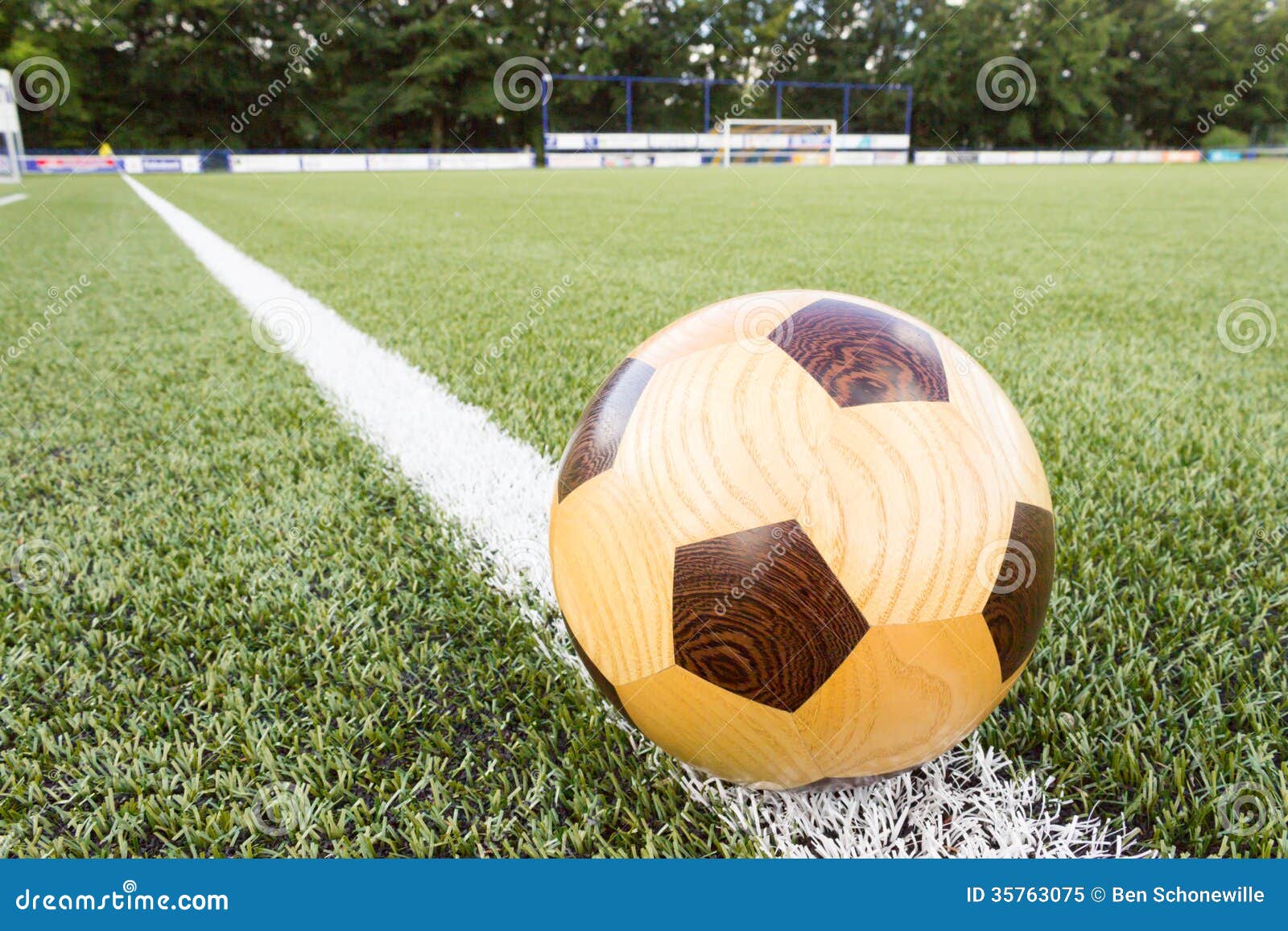 Wooden Football on Sideline Stock Image - Image of field, green: 35763075