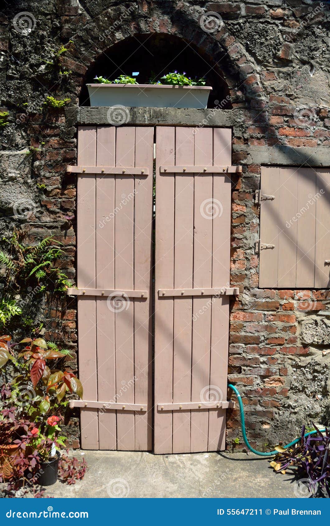 Wooden gate on brick wall stock image. Image of outdoors - 55647211