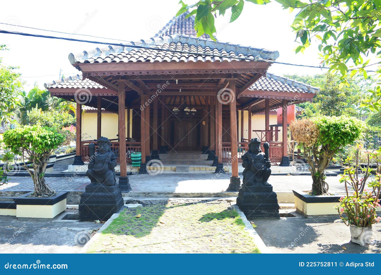 Wooden House in Classic Style with Two Statues in Front of the House ...