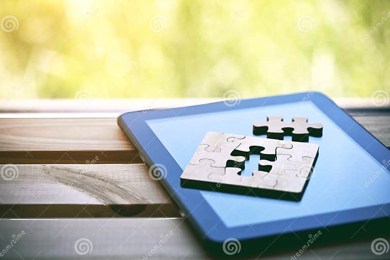 Wooden Jigsaw Puzzle with Tablet Computer Stock Photo - Image of wooden ...