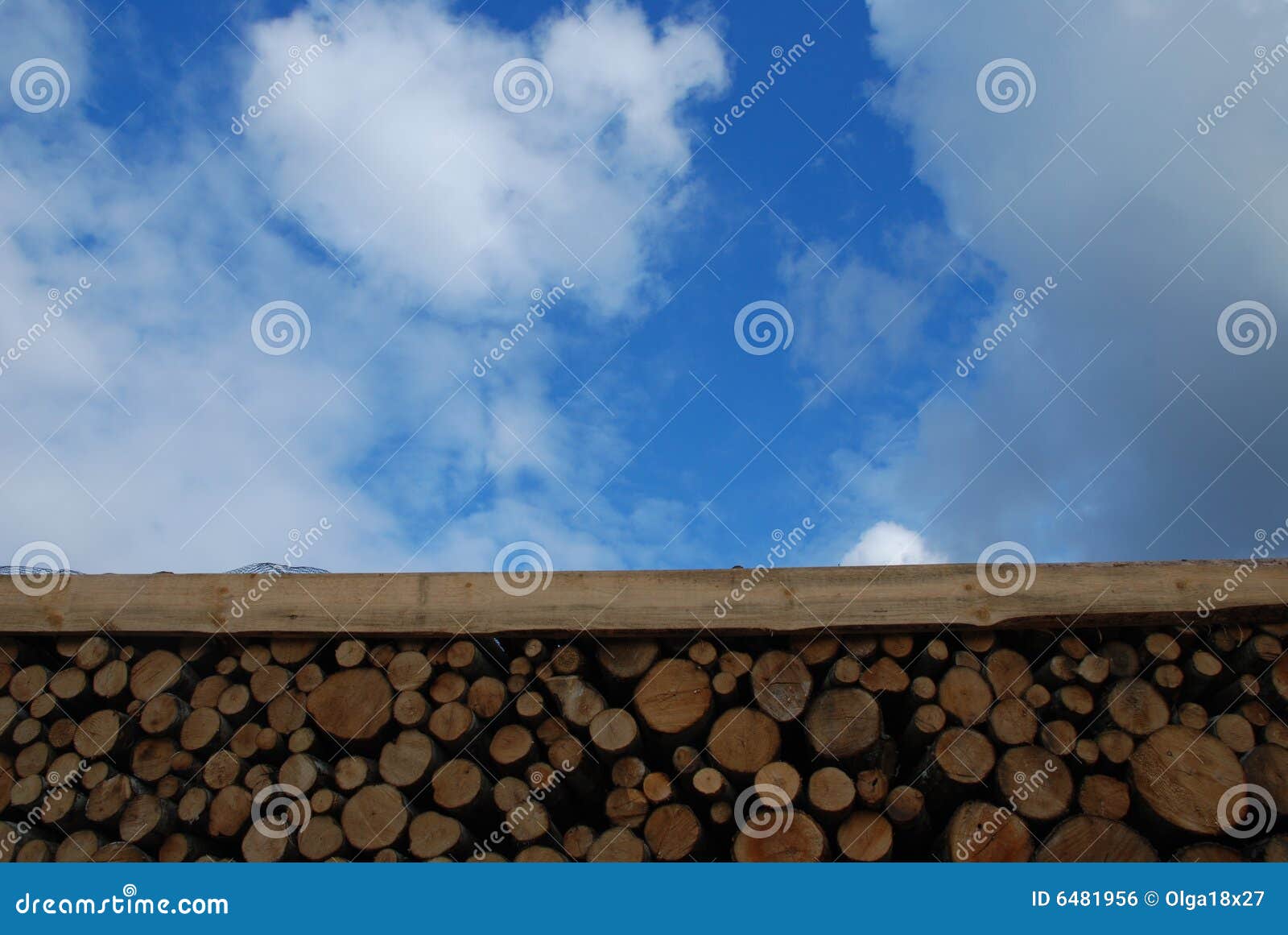 Wooden logs on blue sky stock photo. Image of generation - 6481956