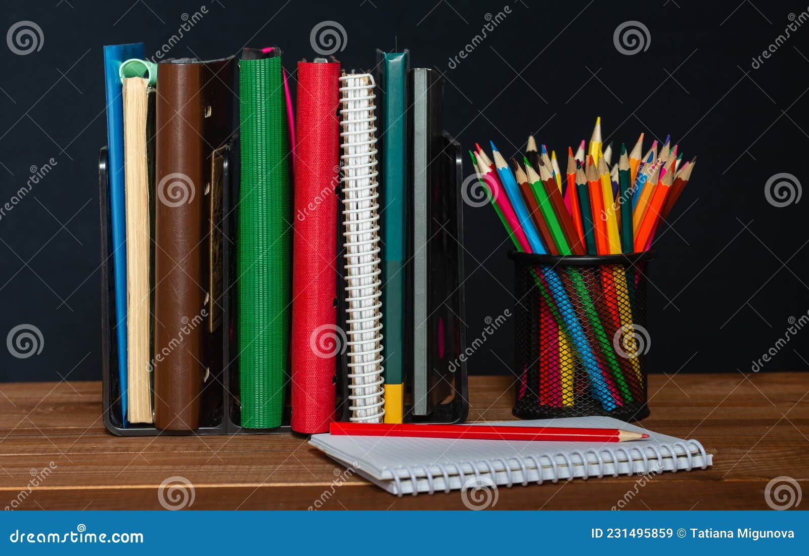 A Stack of Notebooks, a Jar of Pencils and a Notepad on the Table ...