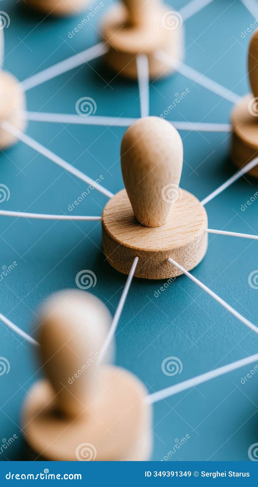 Wooden Pegs Connected by Strings on a Blue Surface Symbolize Networking ...