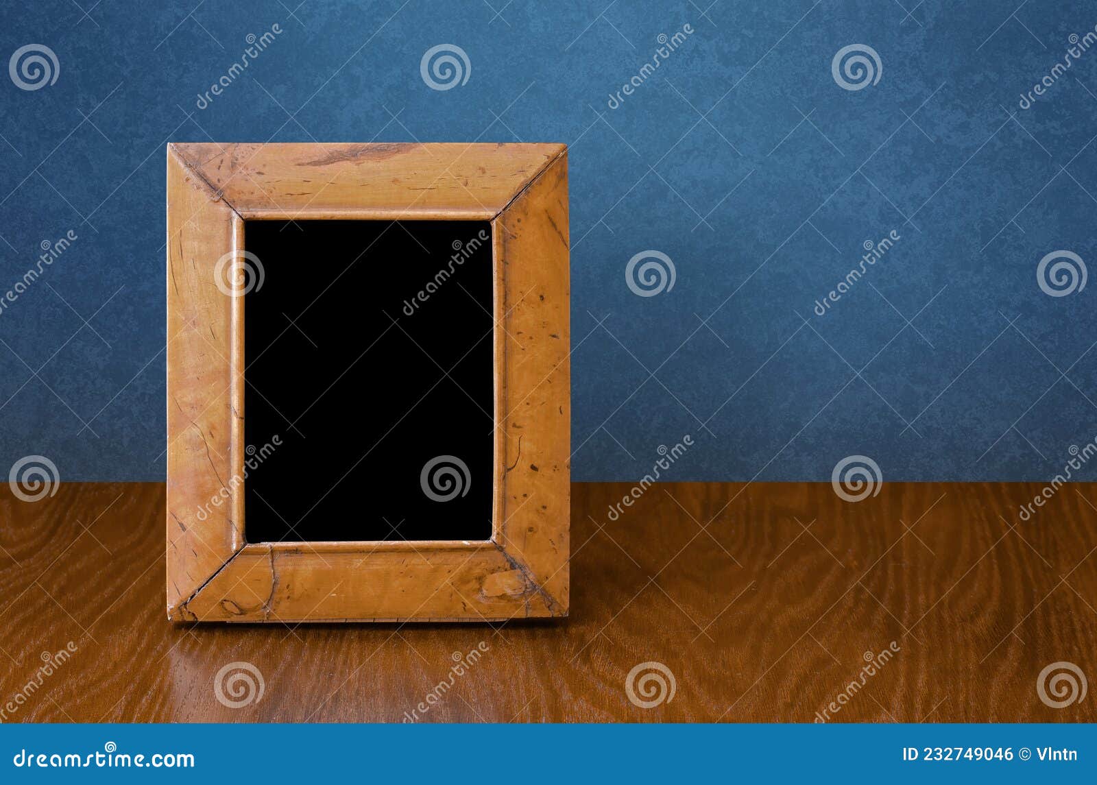 Frame on table, blue wall stock photo. Image of background - 232749046