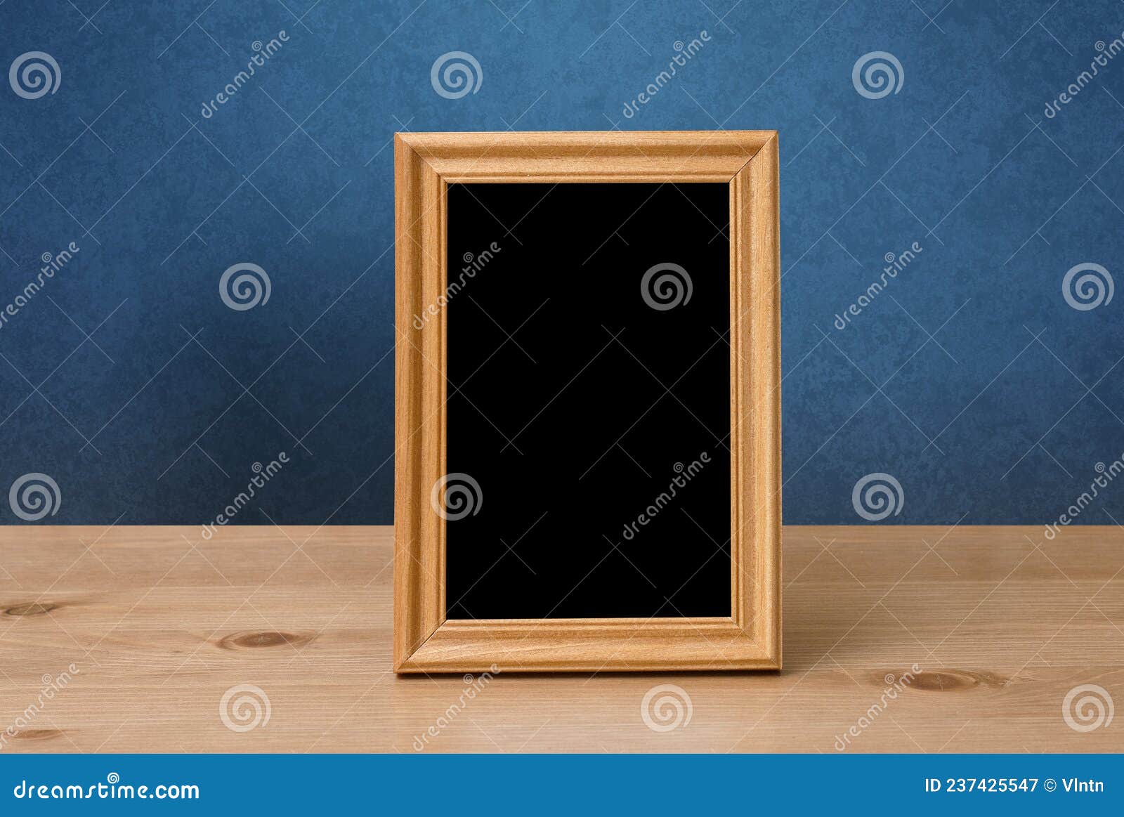 Frame on table, blue wall stock image. Image of wall - 237425547