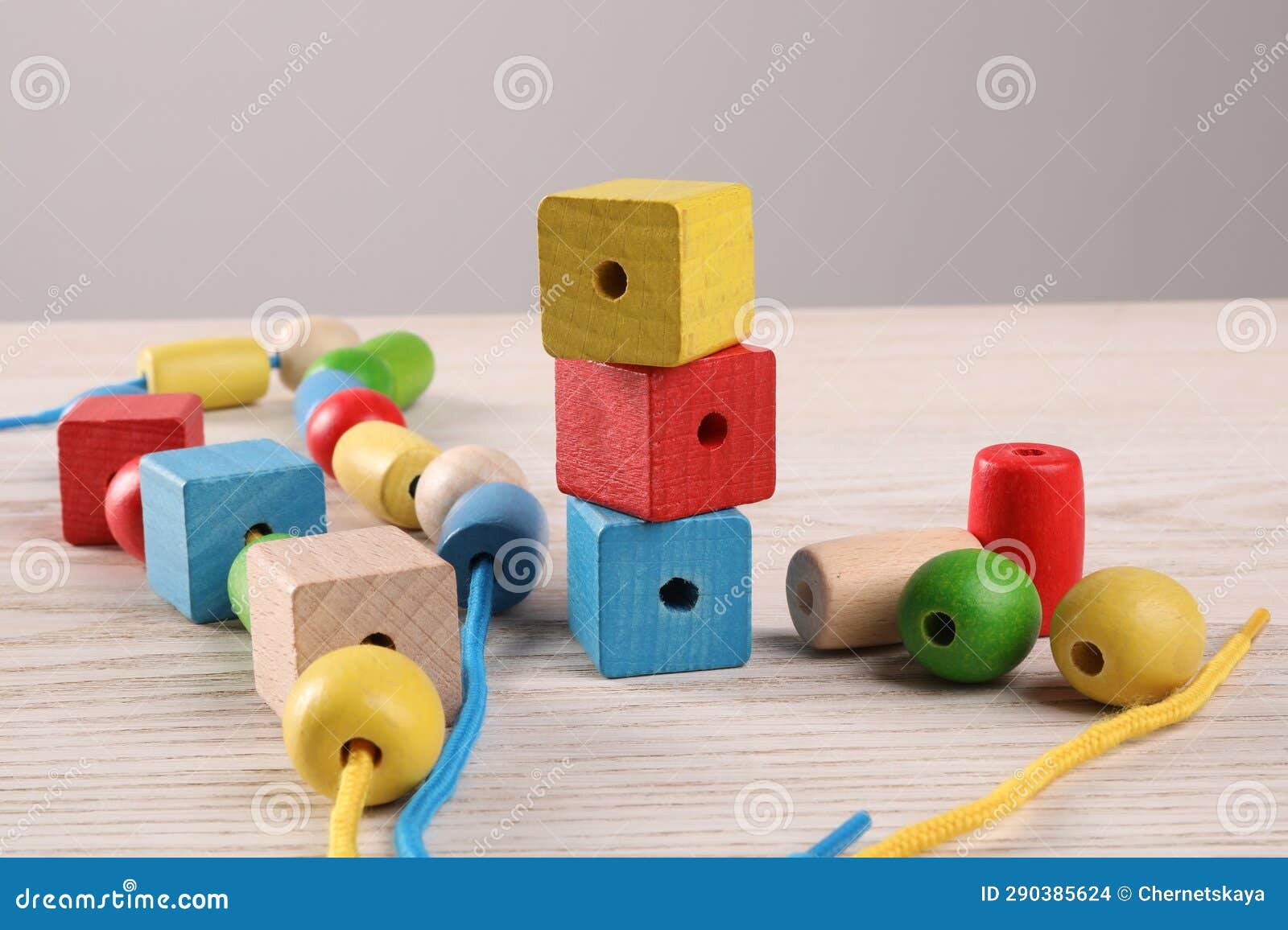 Wooden Pieces and String for Threading Activity on Light Table, Closeup ...