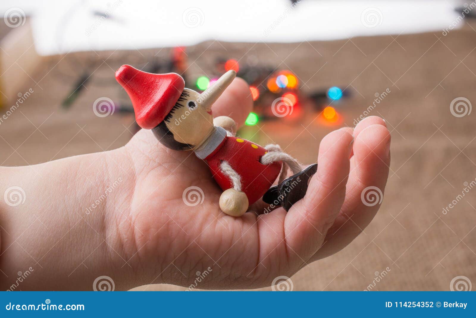 Wooden Pinocchio Doll Sitting in Hand Stock Photo - Image of puppet ...