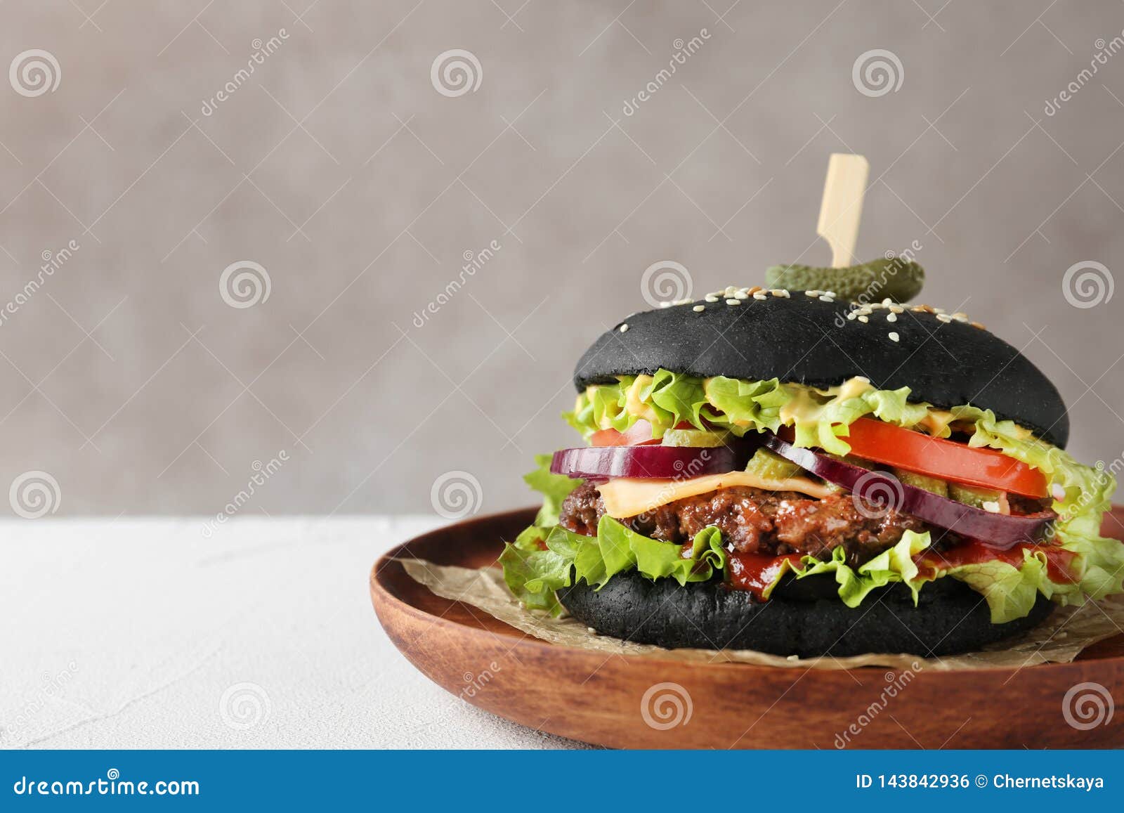 Wooden Plate with Black Burger on Table Stock Photo - Image of lunch ...