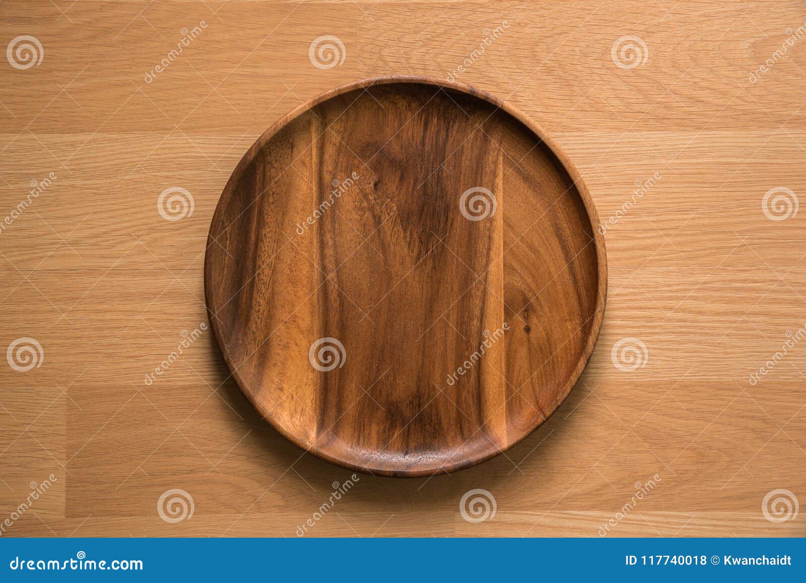 Wooden plate on table stock photo. Image of bowl, plate - 117740018