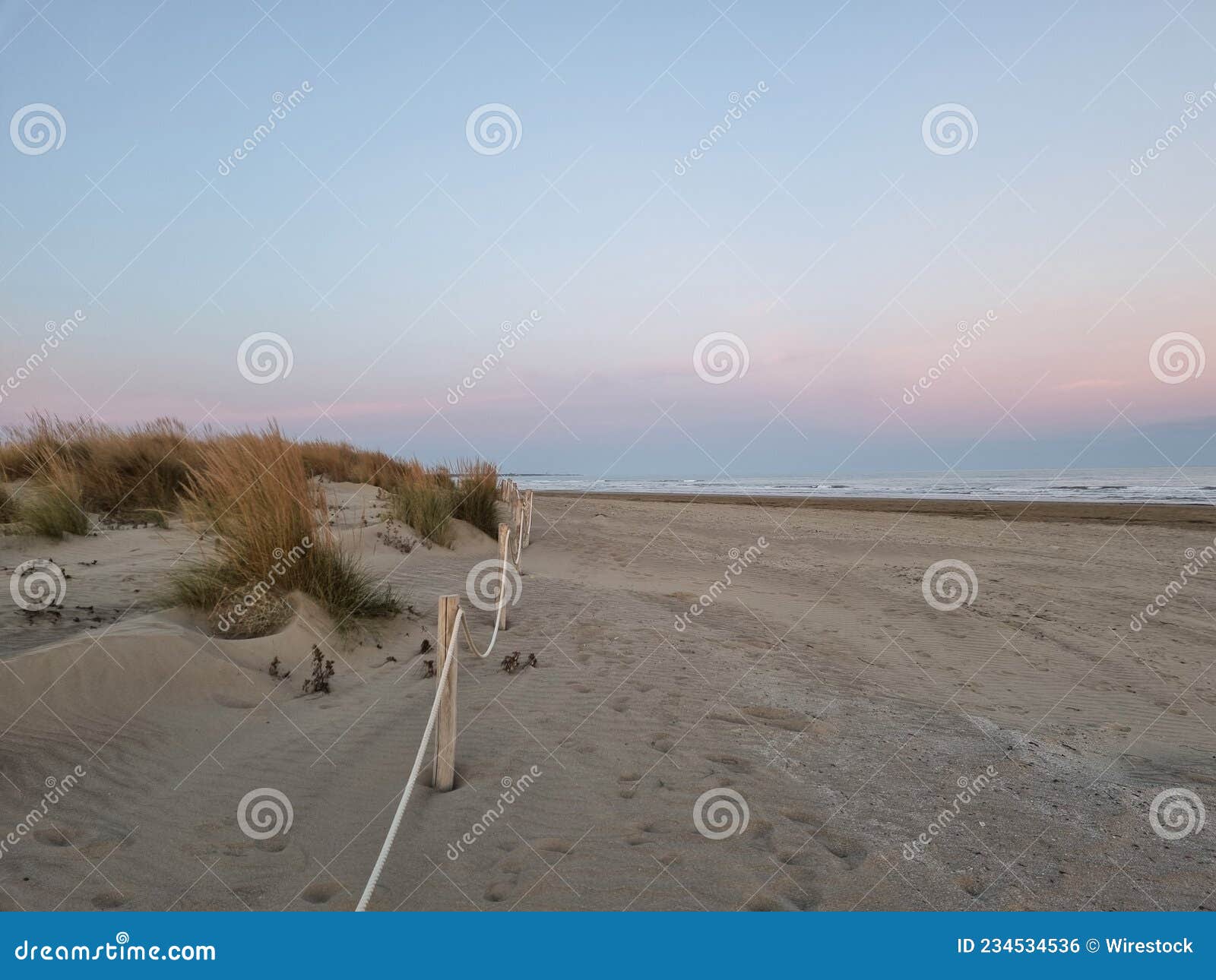 Wooden Poles Connected with Rope in a Sandy Beach Stock Photo - Image ...