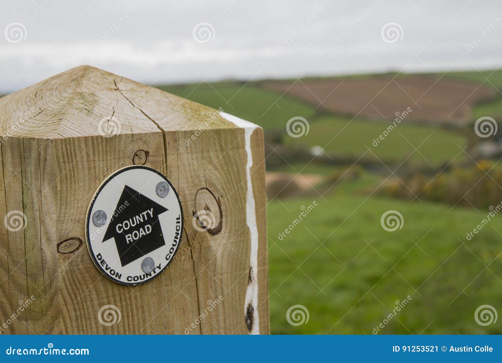 Wooden Post with Devon County Road Sign and Green Fields Beyond. Stock ...