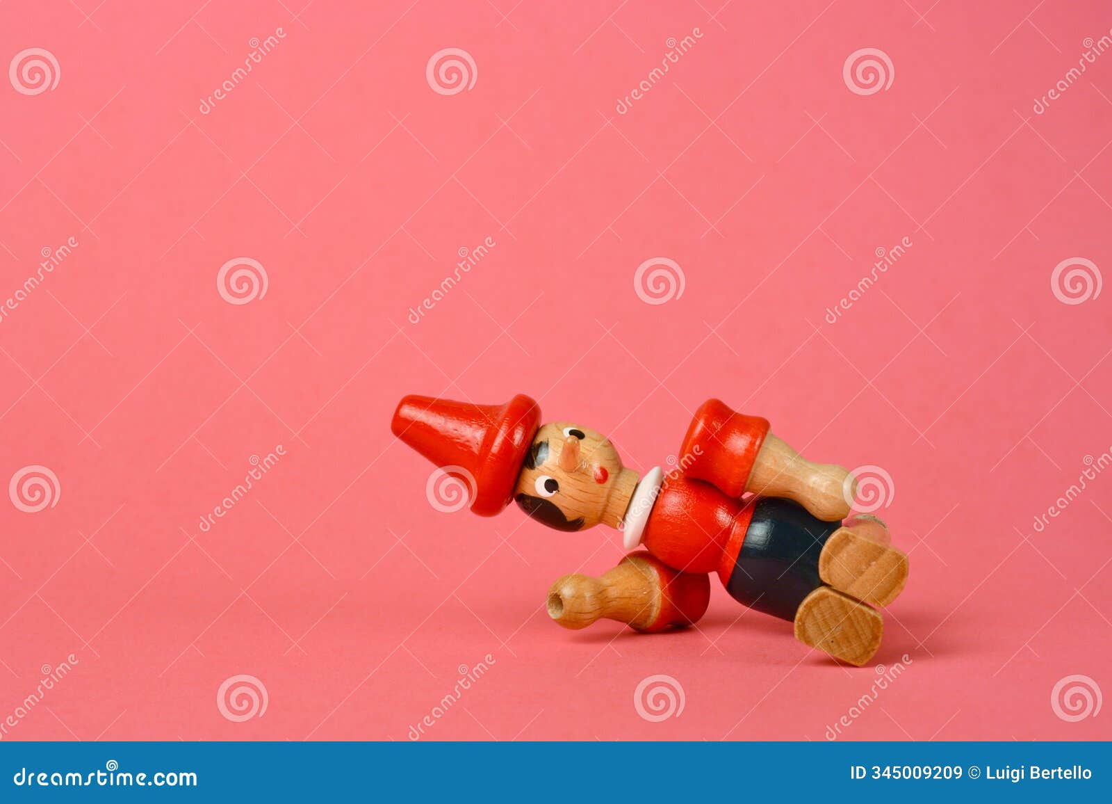 Wooden Puppet Depicting Pinocchio Falling on a Pink Background Stock ...