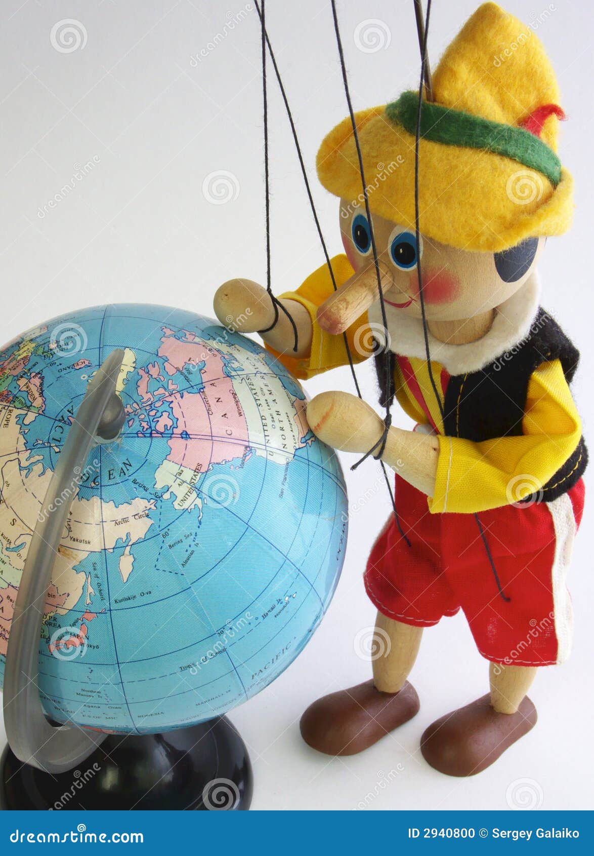 Wooden Puppet Looks at Globe Stock Photo - Image of travel, school: 2940800