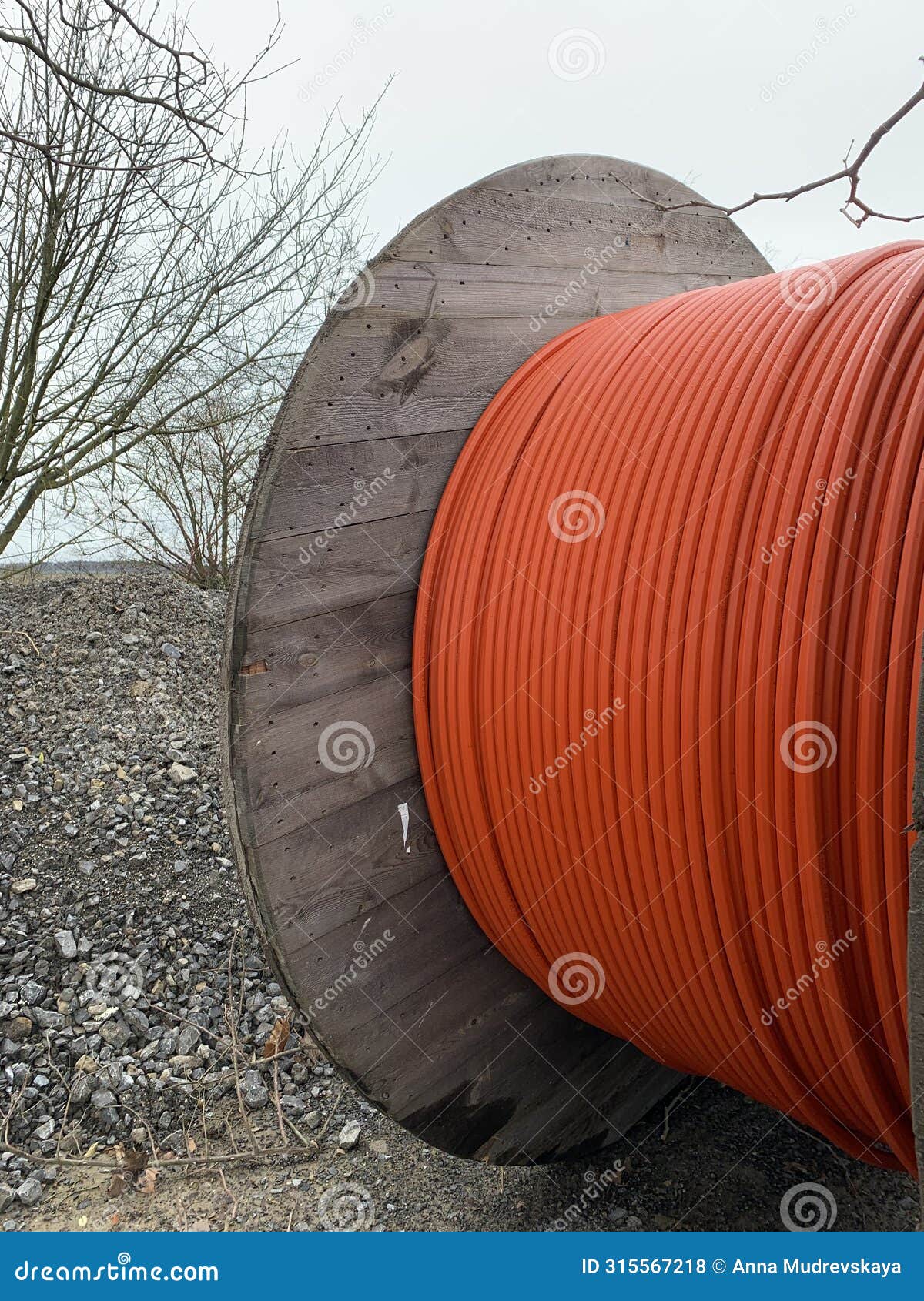 A Wooden Reels with an Orange Cable on a Construction Site. Close Up ...