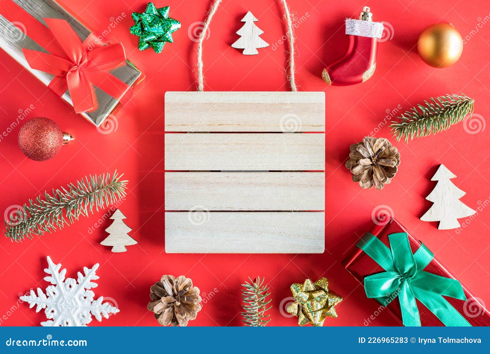 Wooden Sign Board Frame And Christmas Tree Decorations On Red