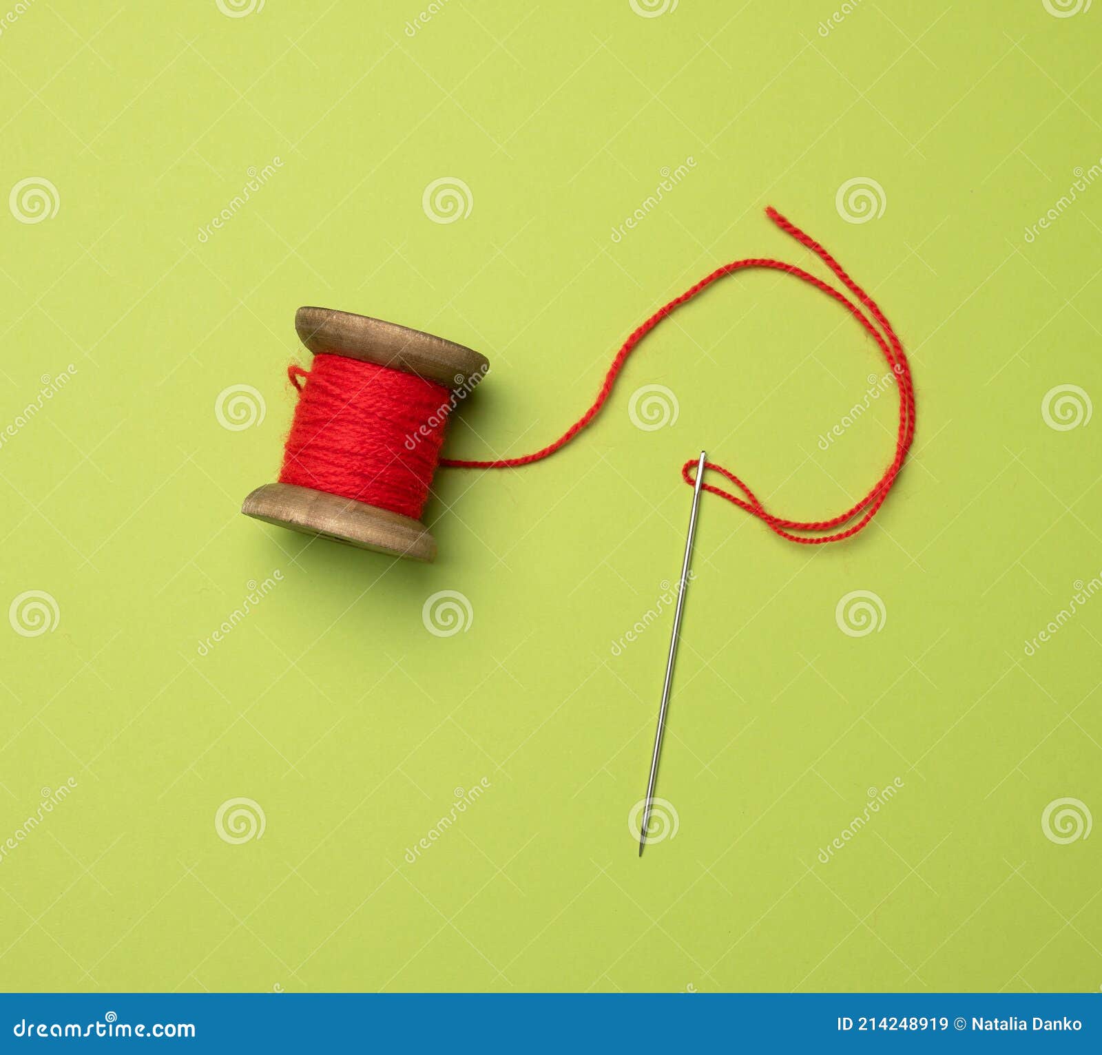 Wooden Spool with Red Wool Thread on a Green Background Stock Image ...