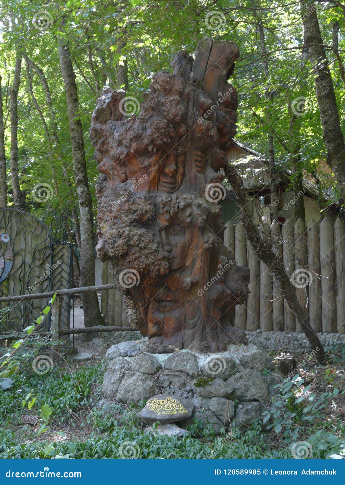 A Wooden Statue is Called a Fairy Tale Tree Featuring Various Faces at ...