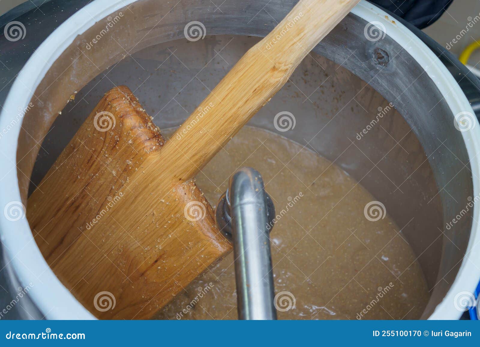 Wooden Stirrer in the Process of Brewing Beer. Background with ...