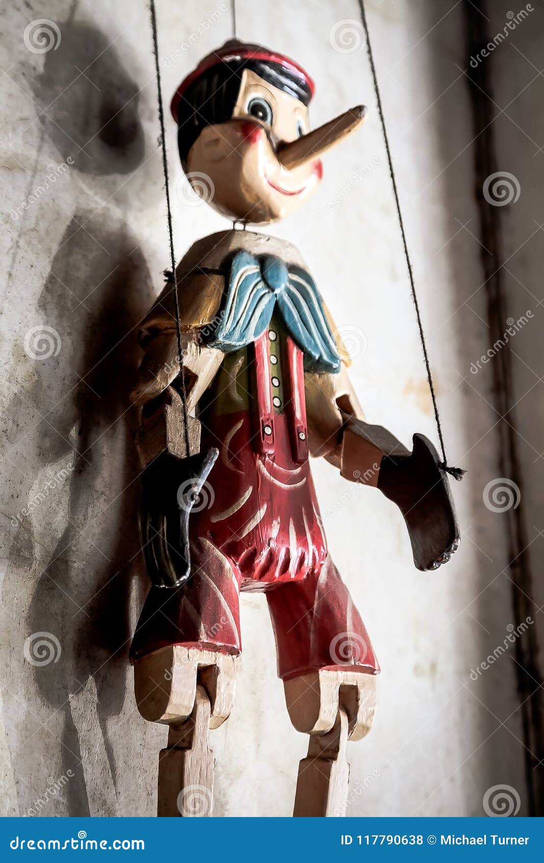 Wooden String Puppet Boy Hanging on a Wall Stock Photo - Image of hand ...