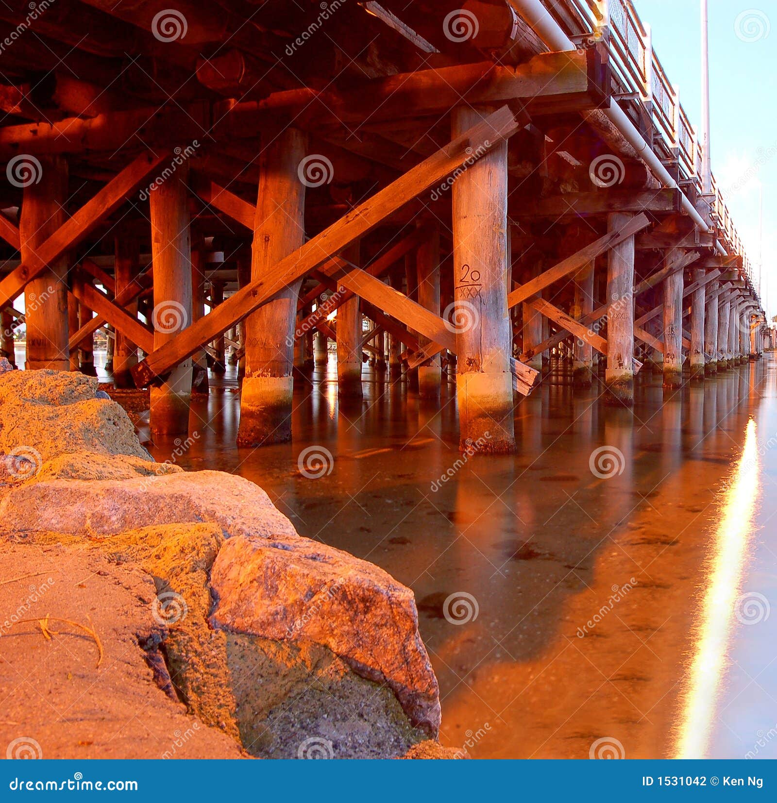 Wooden Support of Pier Bridge Over River and Rock Stock Photo - Image ...