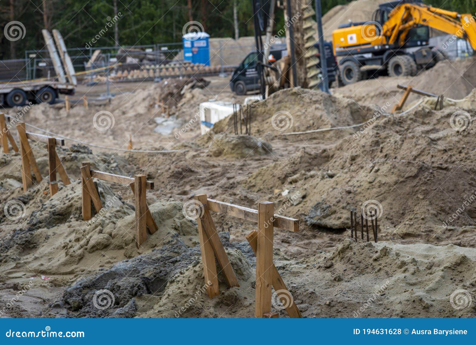 Wooden Supports on the Construction Site. in the Background Backhoe ...