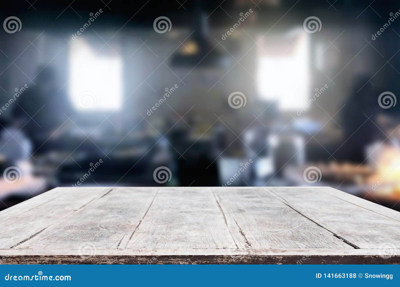 Wooden Table on Abstract Blurred Kitchen with Chef Cooking in ...