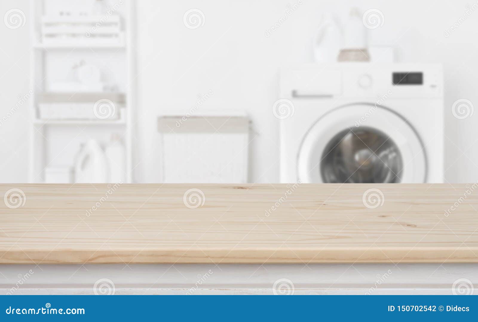 Wooden Table in Front of Defocused Washing Machine and Laundry Stock ...