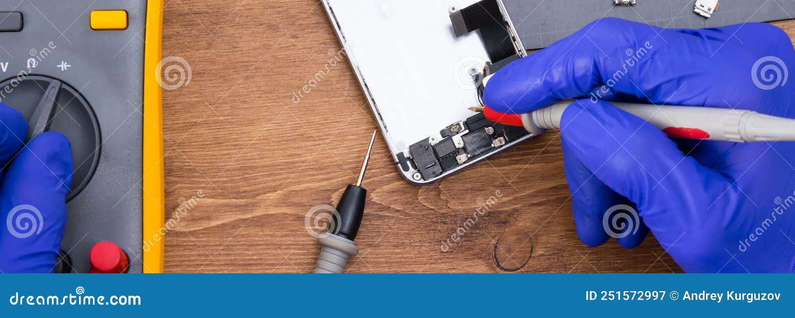 On a Wooden Table with the Help of a Tester, the Process of Repairing a ...