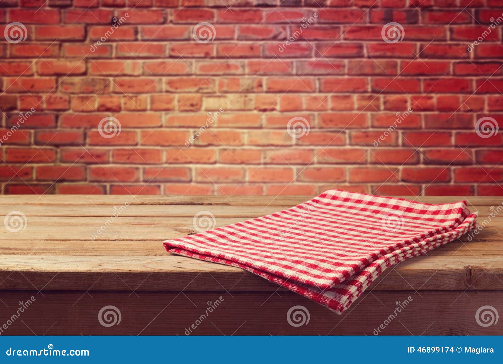 Wooden Table with Red Checked Tablecloth Over Brick Wall Stock Photo ...