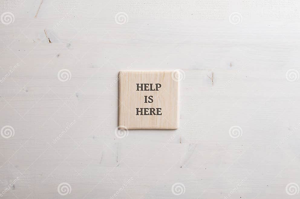 Wooden Tile with a Help is Here Sign Written on it Stock Photo - Image ...