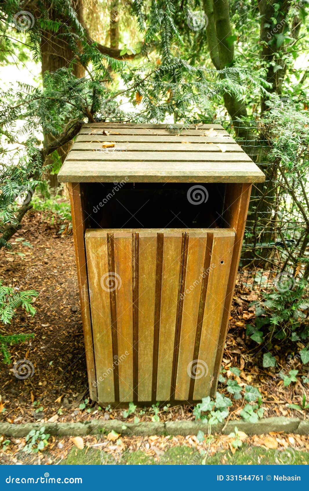 Wooden Trash Bin in Forest Setting Surrounded by Green Foliage and ...