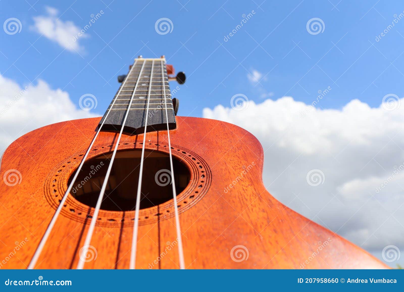 Wooden Ukulele with Blue Sky and Clouds Behind Stock Photo - Image of ...