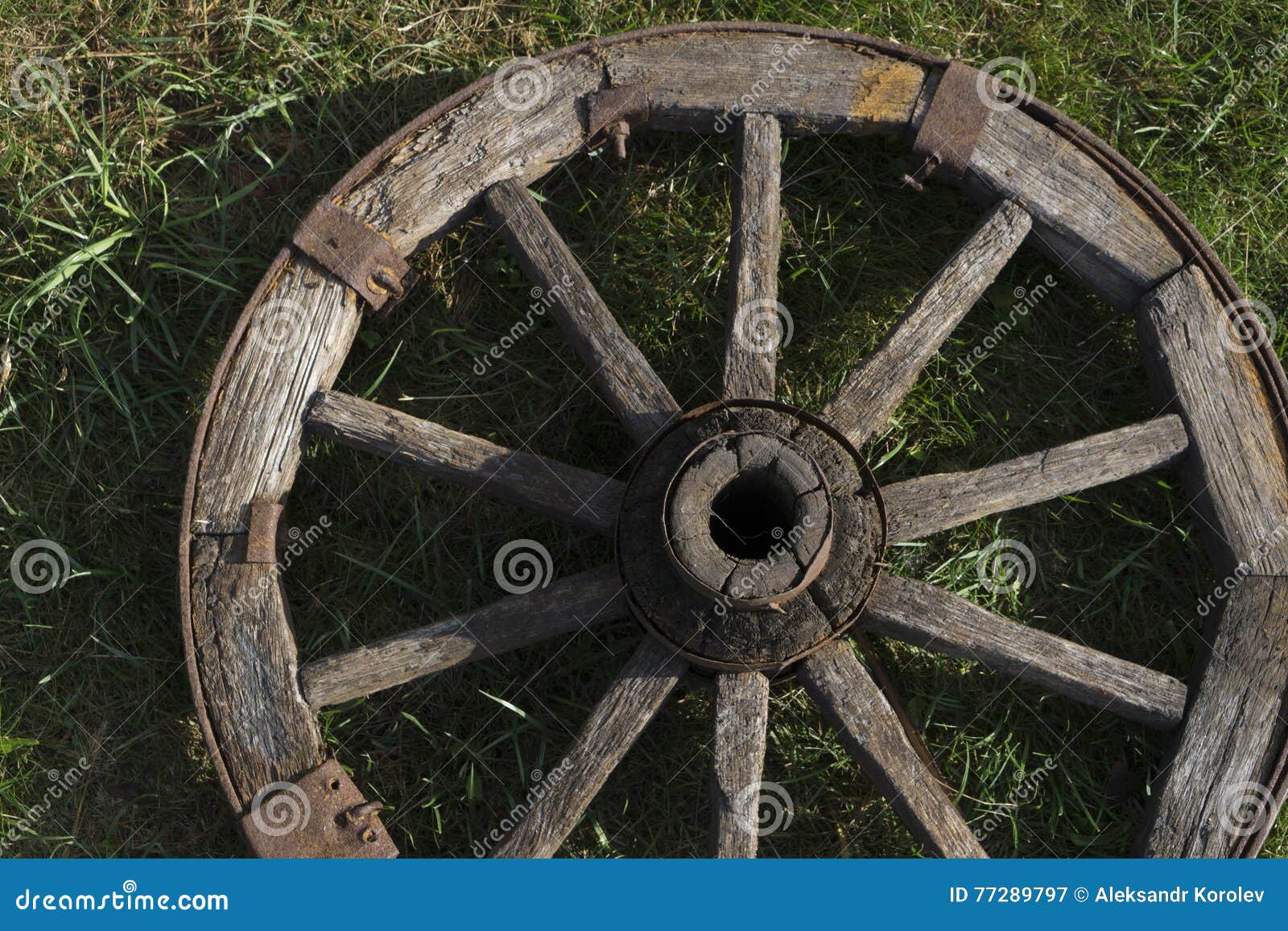 Wooden Wheel on a Background of Green Grass Stock Image - Image of ...