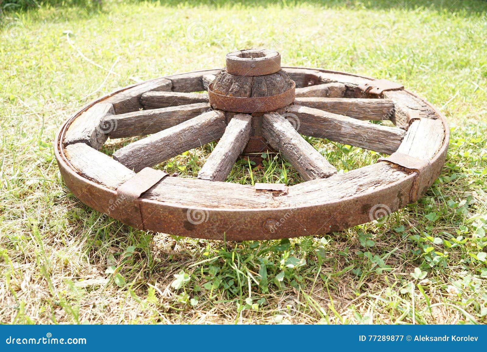 Wooden Wheel on a Background of Green Grass Stock Image - Image of ...