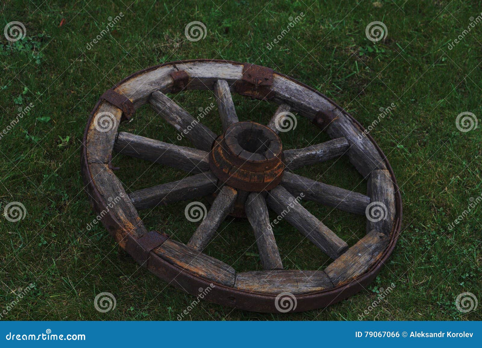 Wooden Wheel on a Background of Green Grass Stock Photo - Image of ...