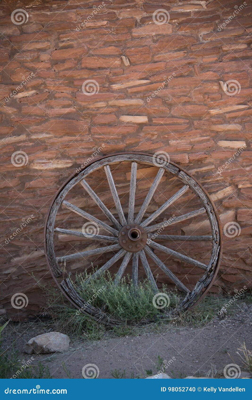 Wooden Wheel on Brick Wall Vertical Stock Photo - Image of western ...
