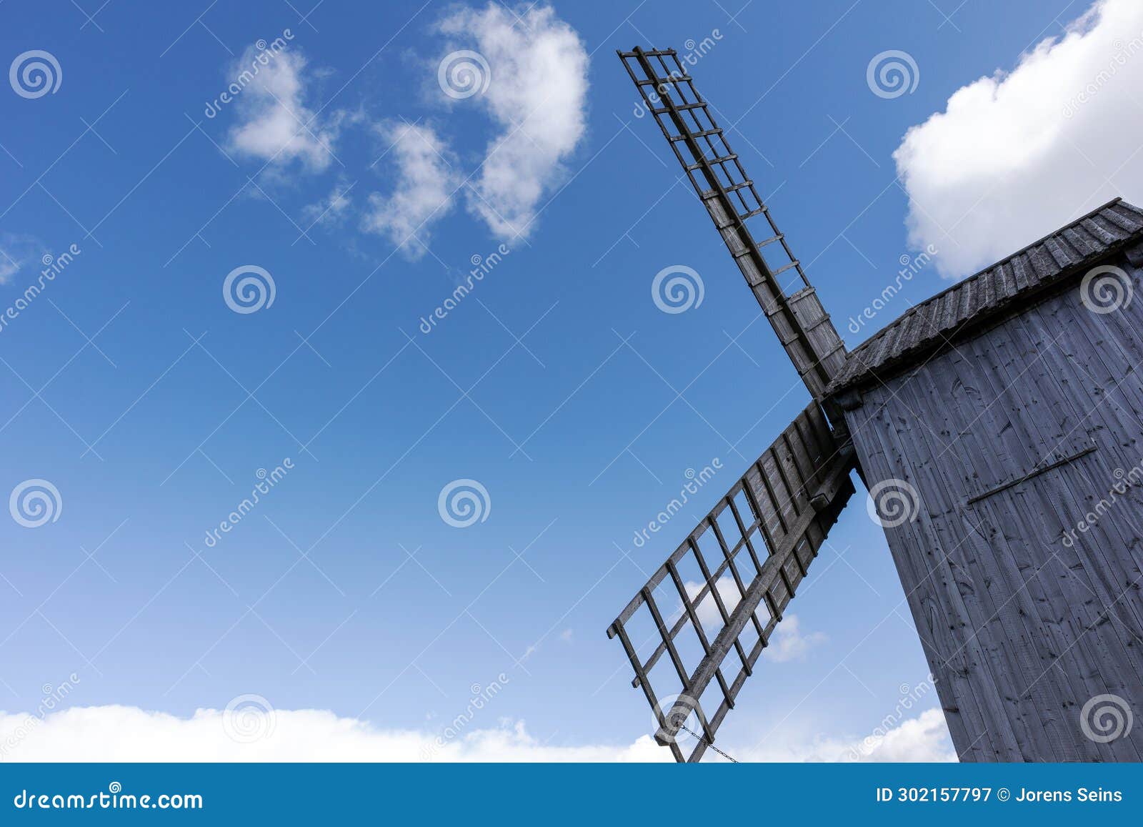 Wooden Windmill Wings on a Background of Blue Sky and Clouds Stock ...