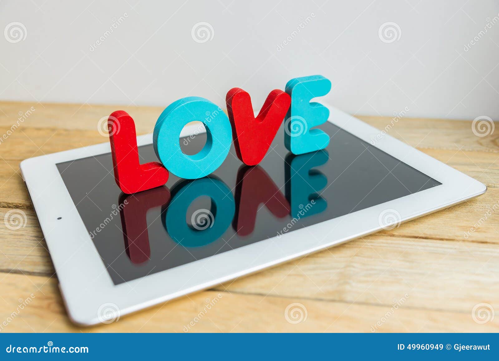 Wooden Word LOVE Stand on Tablet Stock Image - Image of computer ...