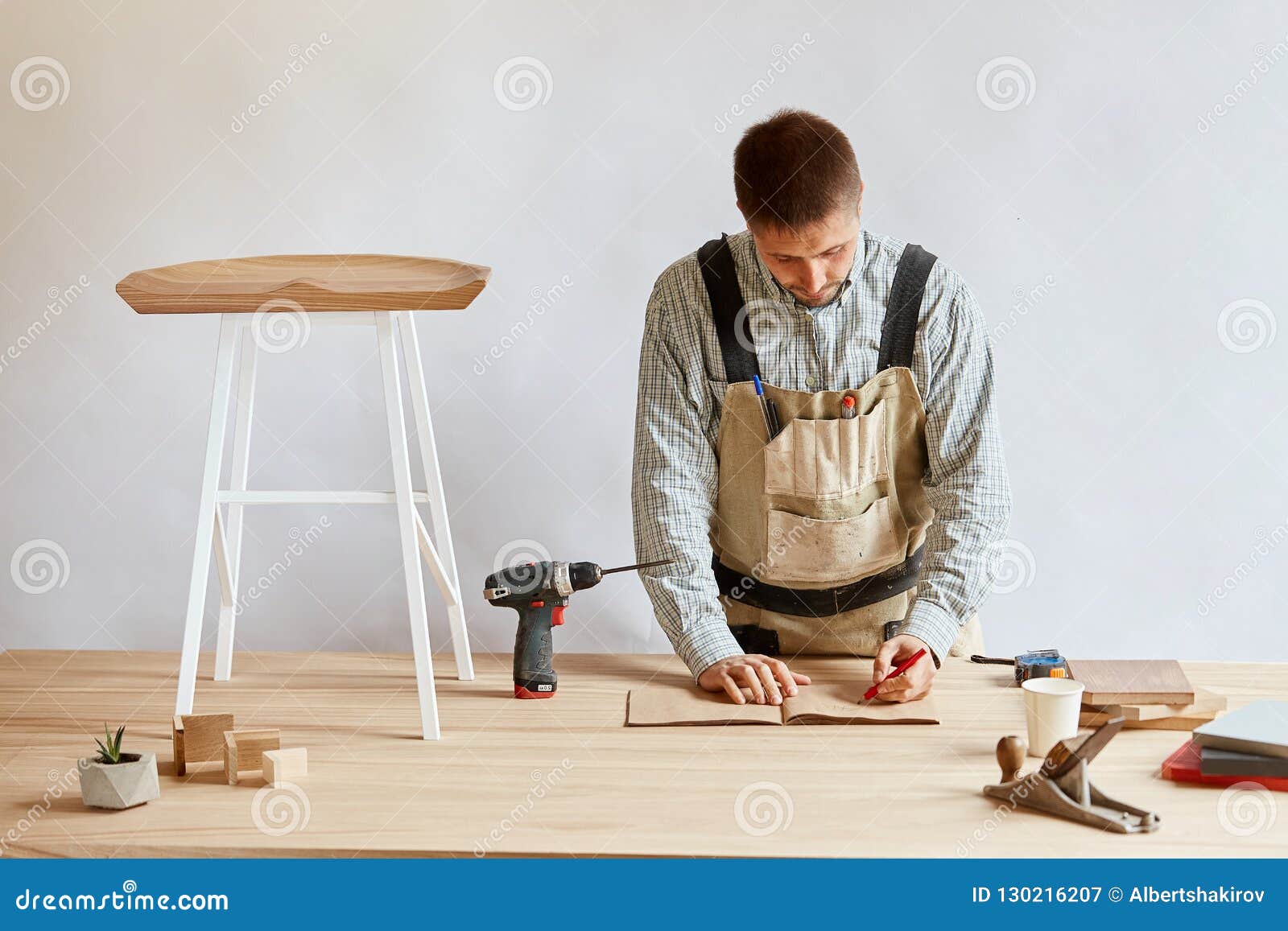 Carpenter Man Making Draft Plan Using Pencil on the Table with Tools ...
