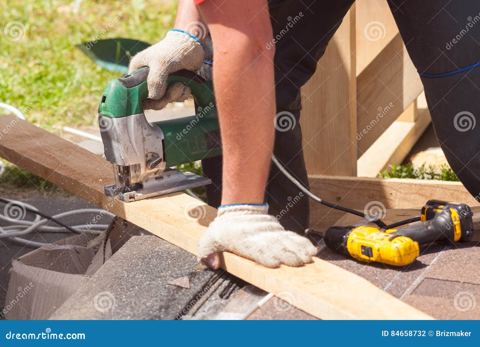 Woodworker Cutting a Piece of Wood Using a Jigsaw. Stock Photo - Image ...