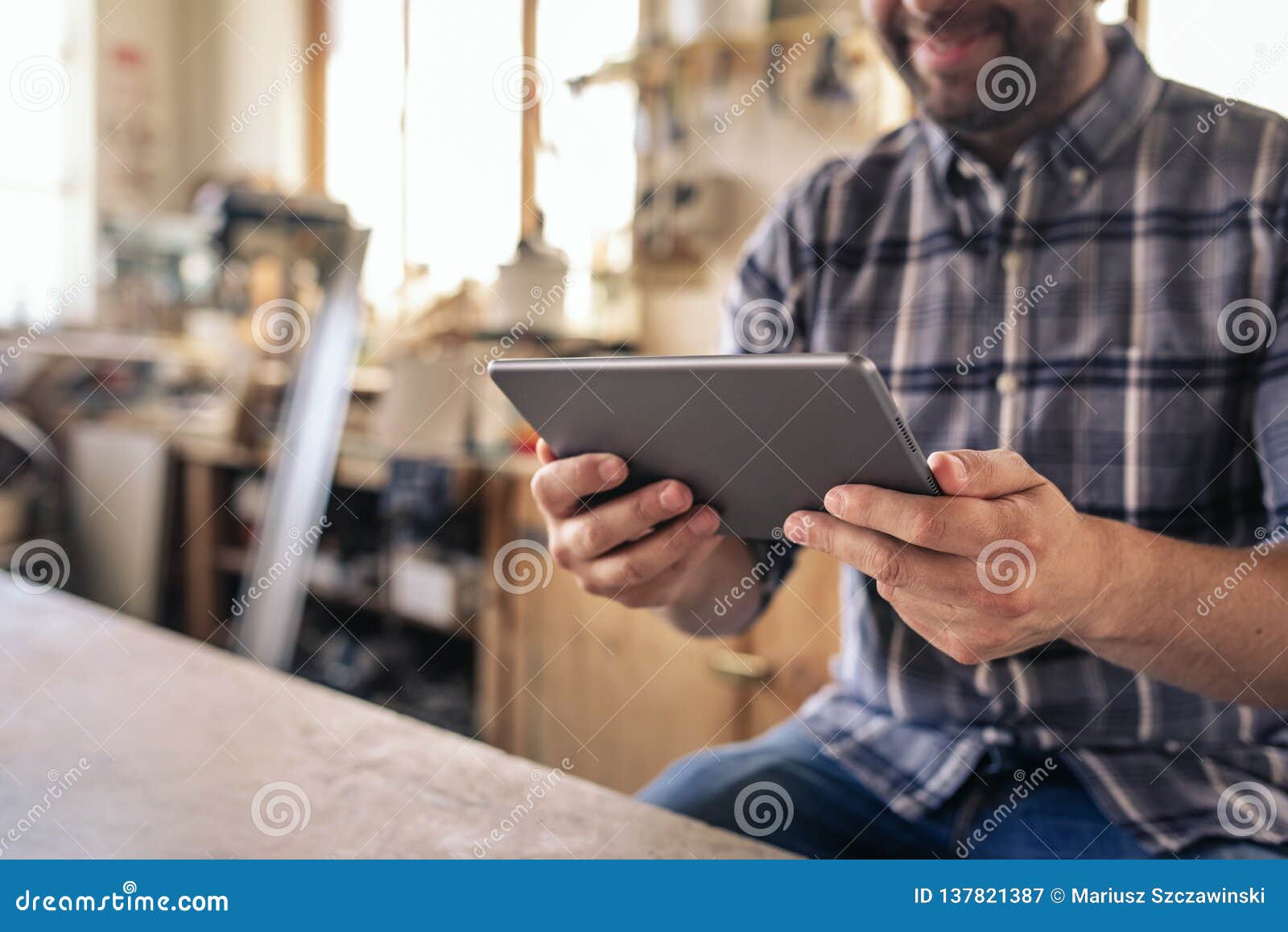 Woodworker Sitting in His Workshop Using a Digital Tablet Stock Image ...