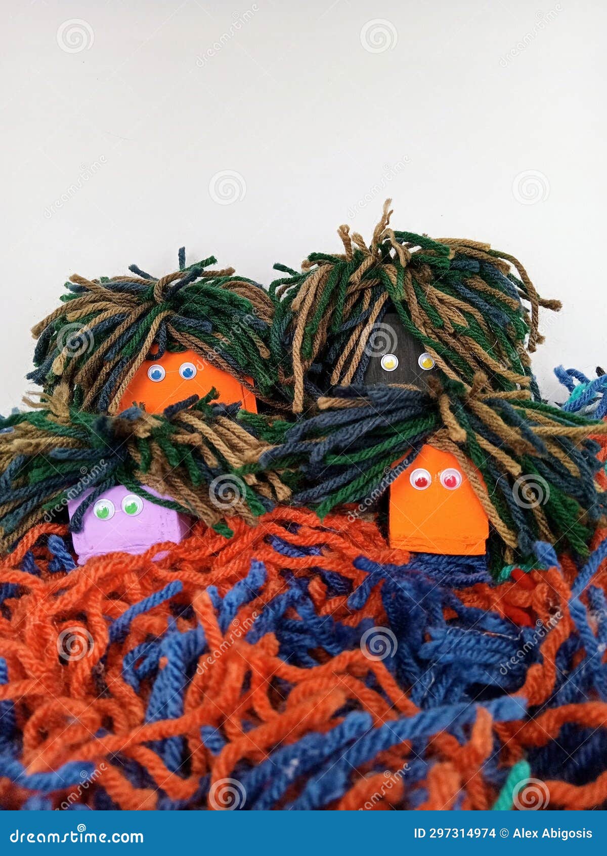 Wool Characters with Googly Eyes and Yarn Hair on a White Background ...