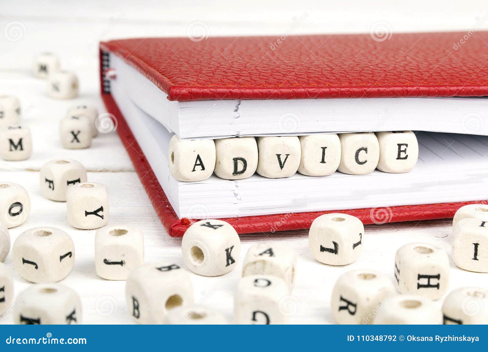 Word Advice Written in Wooden Blocks in Red Notebook on White Wooden ...