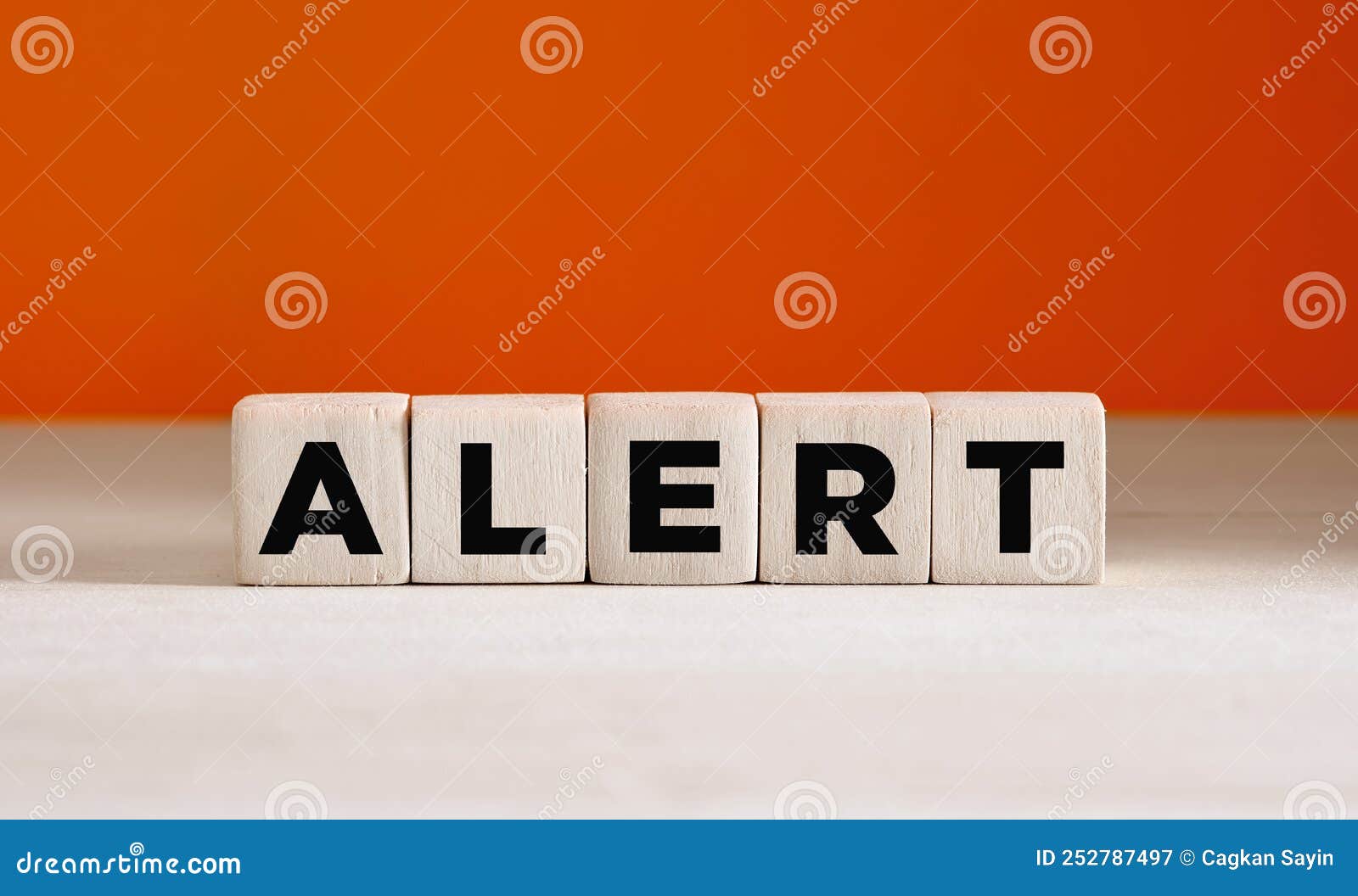 The Word Alert on Wooden Cubes on Orange Background with Copy Space ...