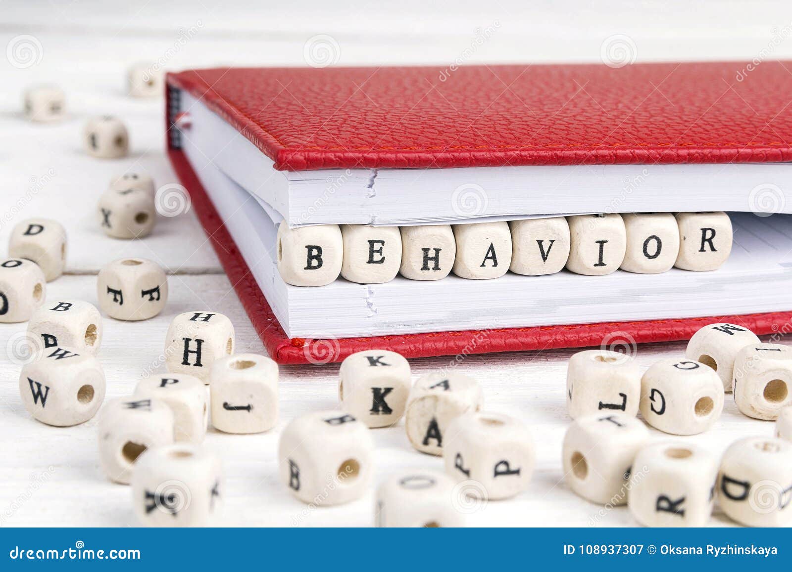 Word Behavior Written in Wooden Blocks in Notebook on White Wood Stock ...