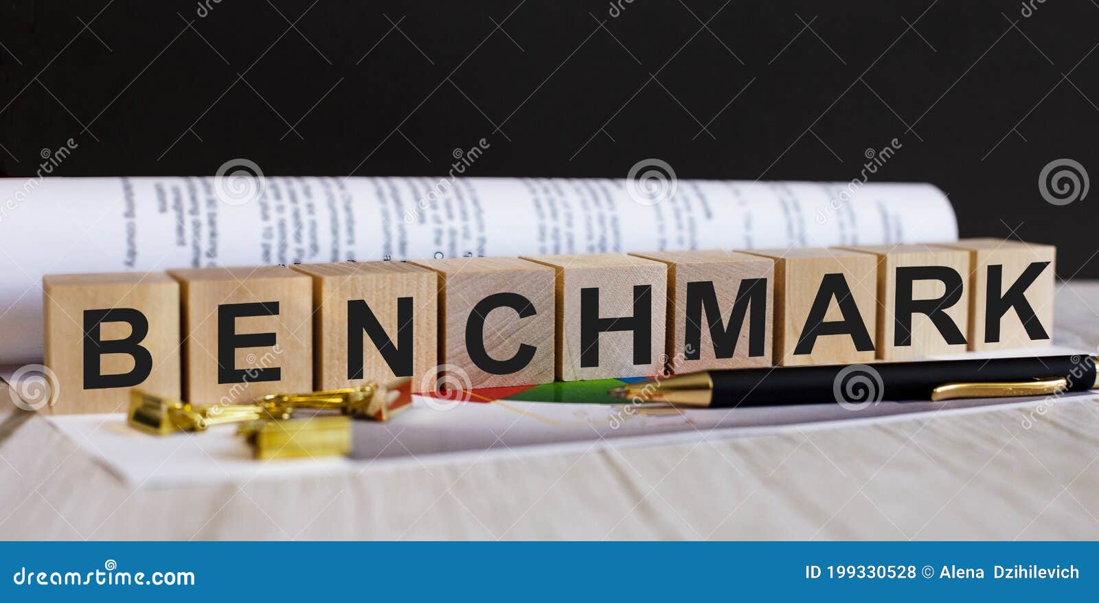 The Word BENCHMARK is Written on Wooden Cubes Near the Pen and Document ...
