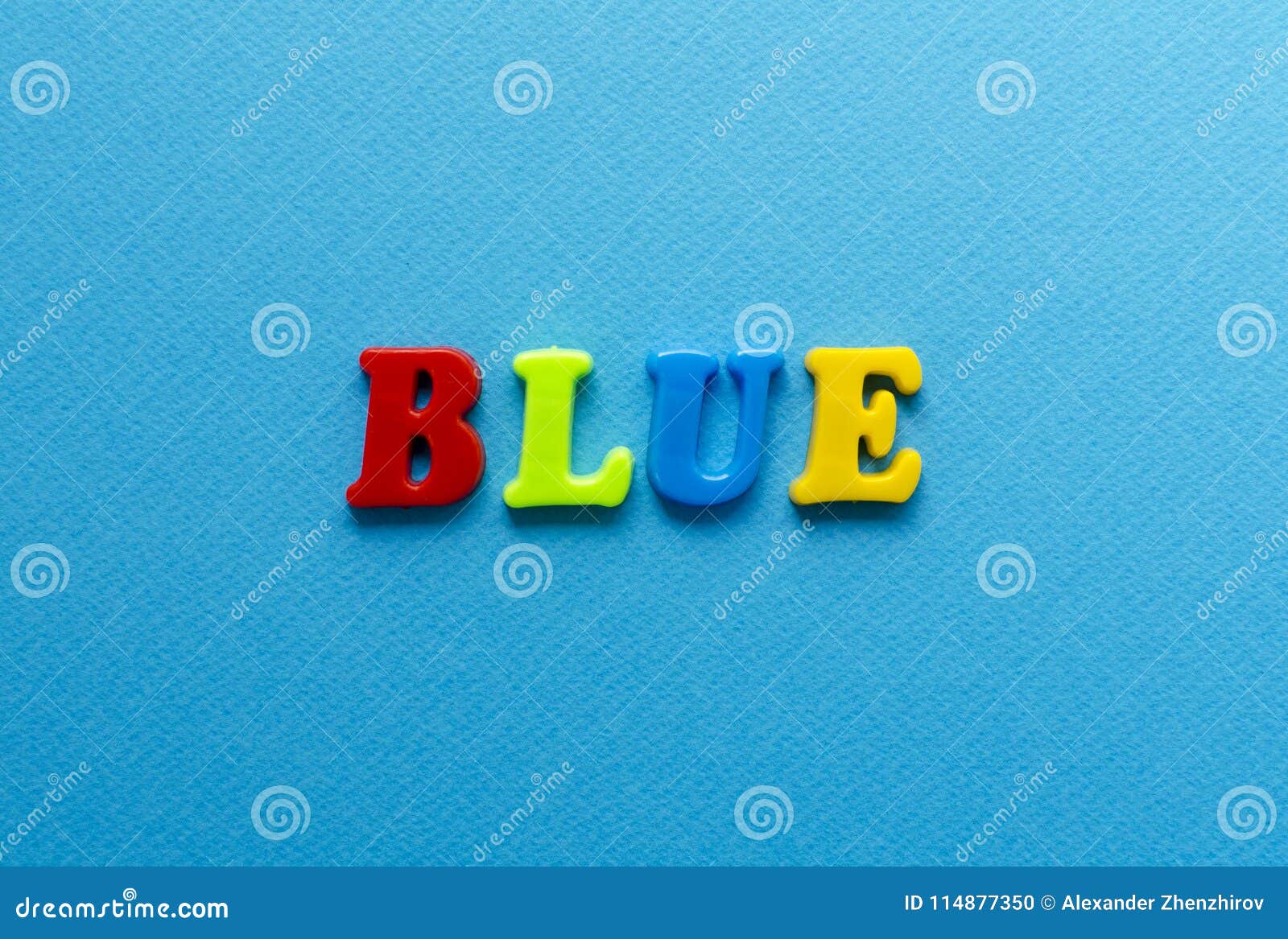Word `blue` from Plastic Coloured Magnet Letters on Blue Paper B Stock ...